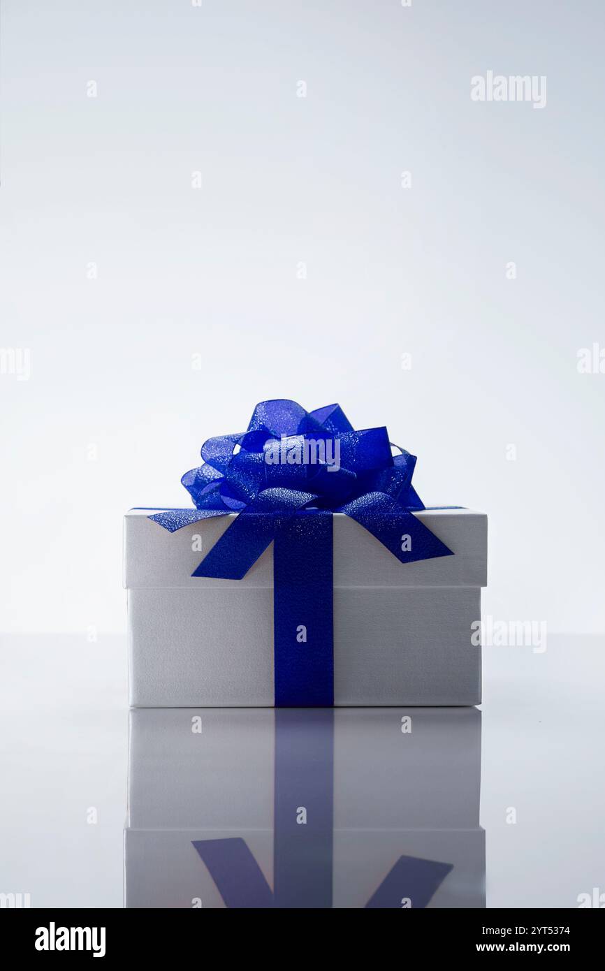 Gift box with blue ribbon Stock Photo - Alamy