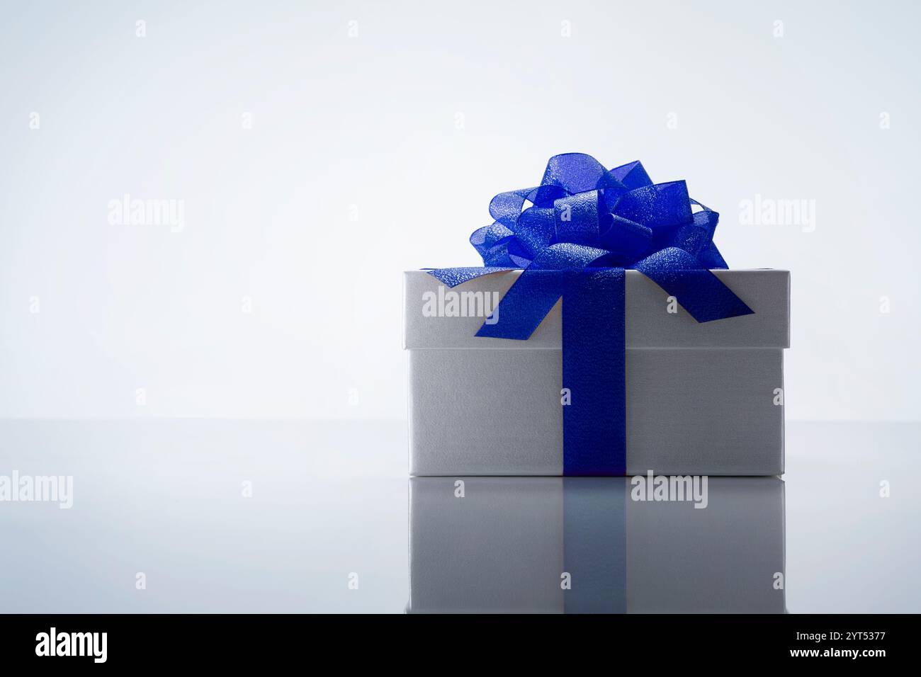 Gift box with blue ribbon Stock Photo - Alamy