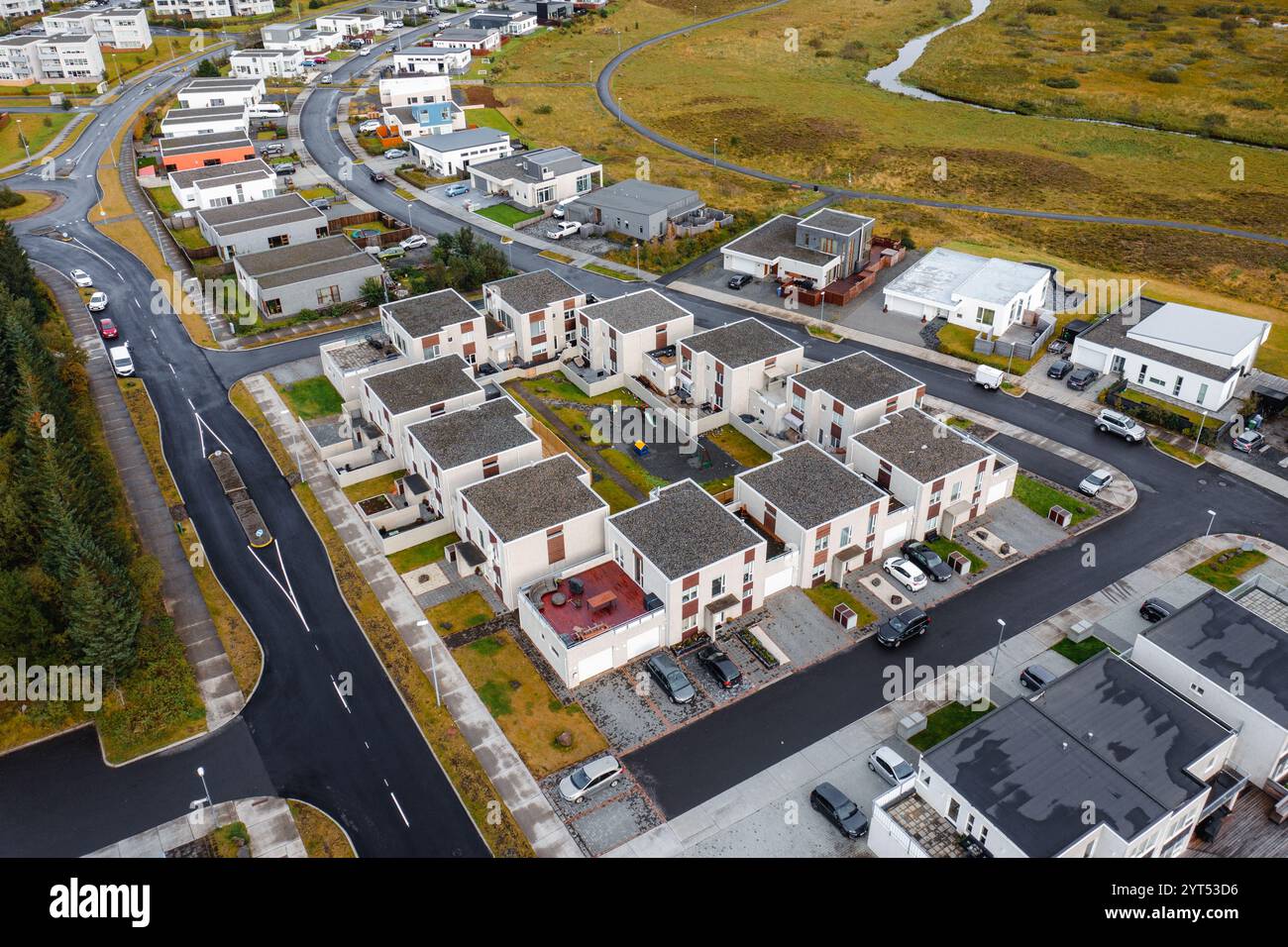 Aerial view showcases a cluster of modern houses in a well-planned ...