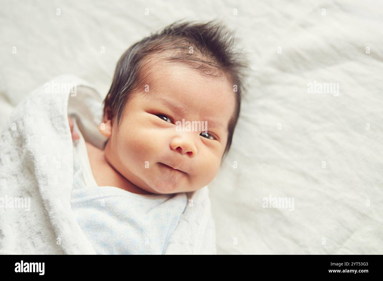 Baby looking at camera Stock Photo - Alamy