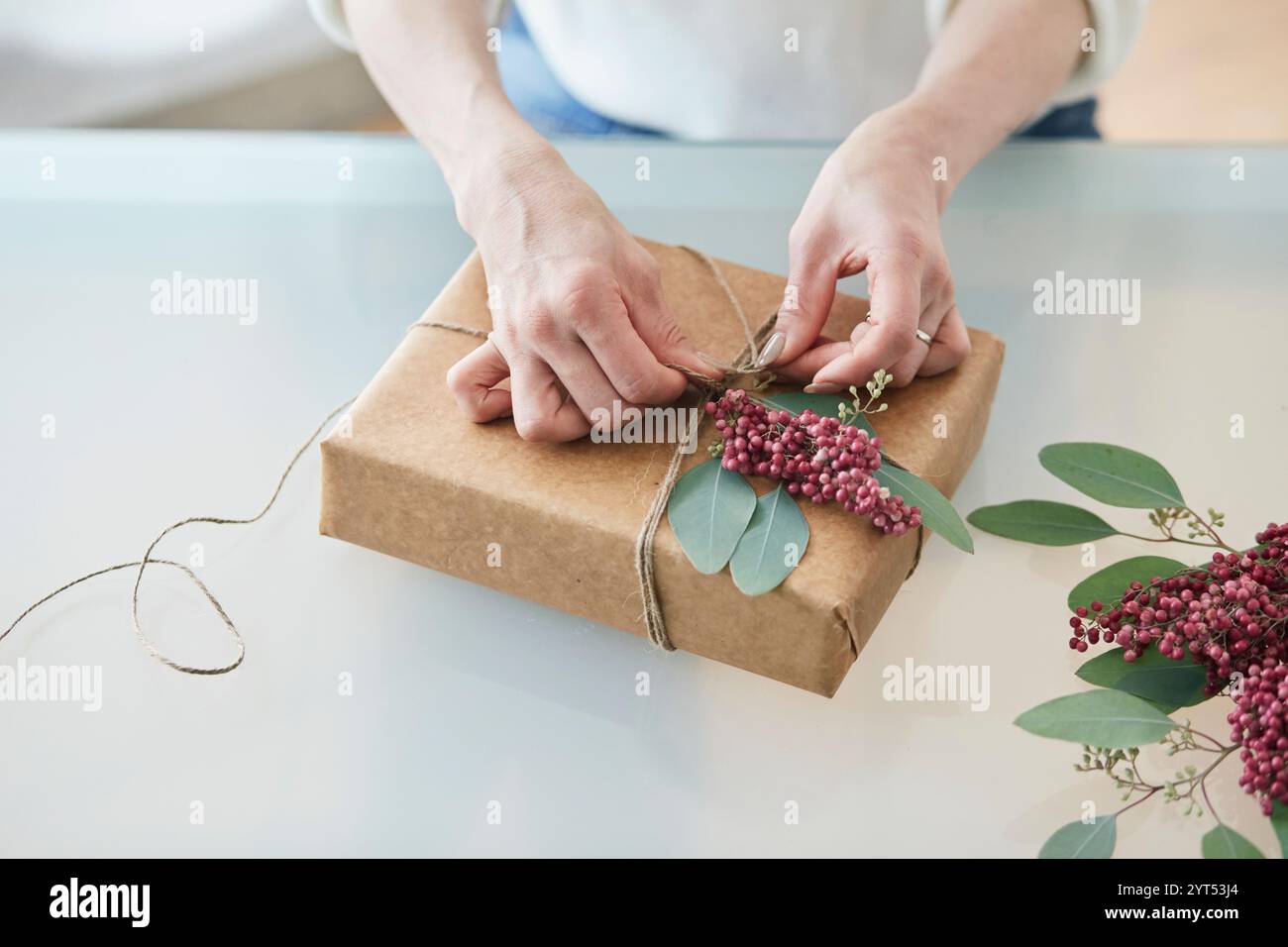Woman's hand wrapping a gift Stock Photo - Alamy
