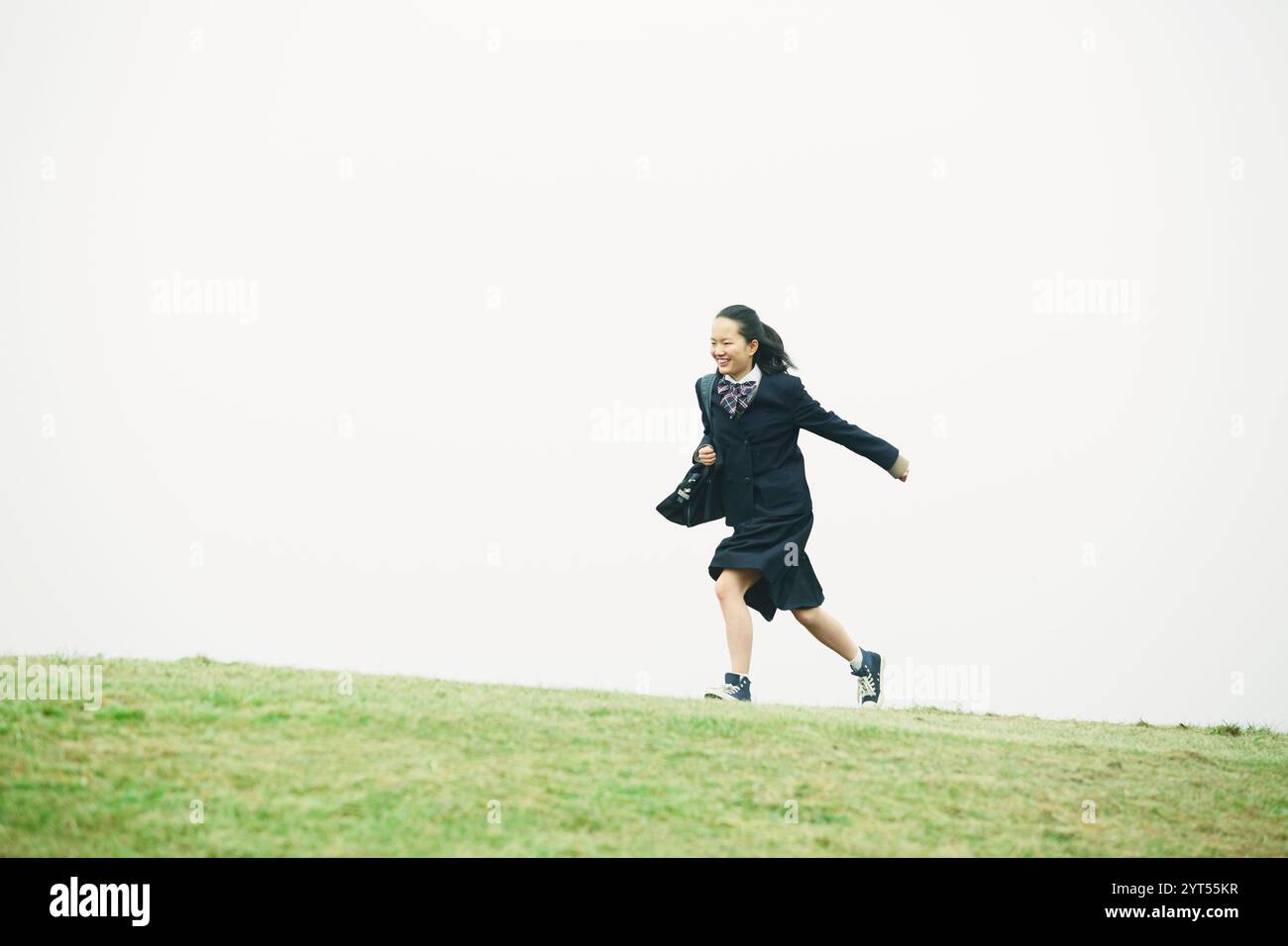 Girl running in uniform Stock Photo - Alamy