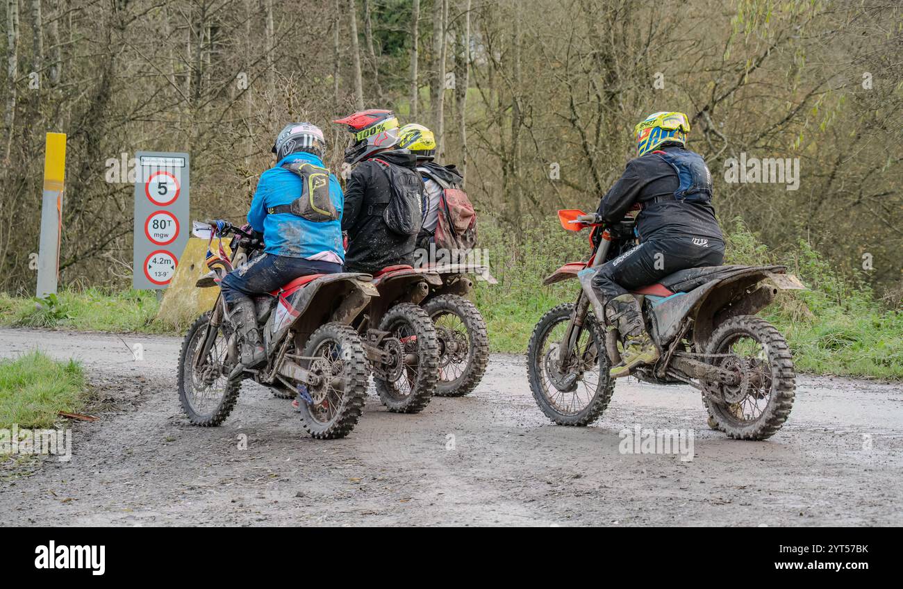 a group of four motor cyclists (bikers) riding their off-road ...