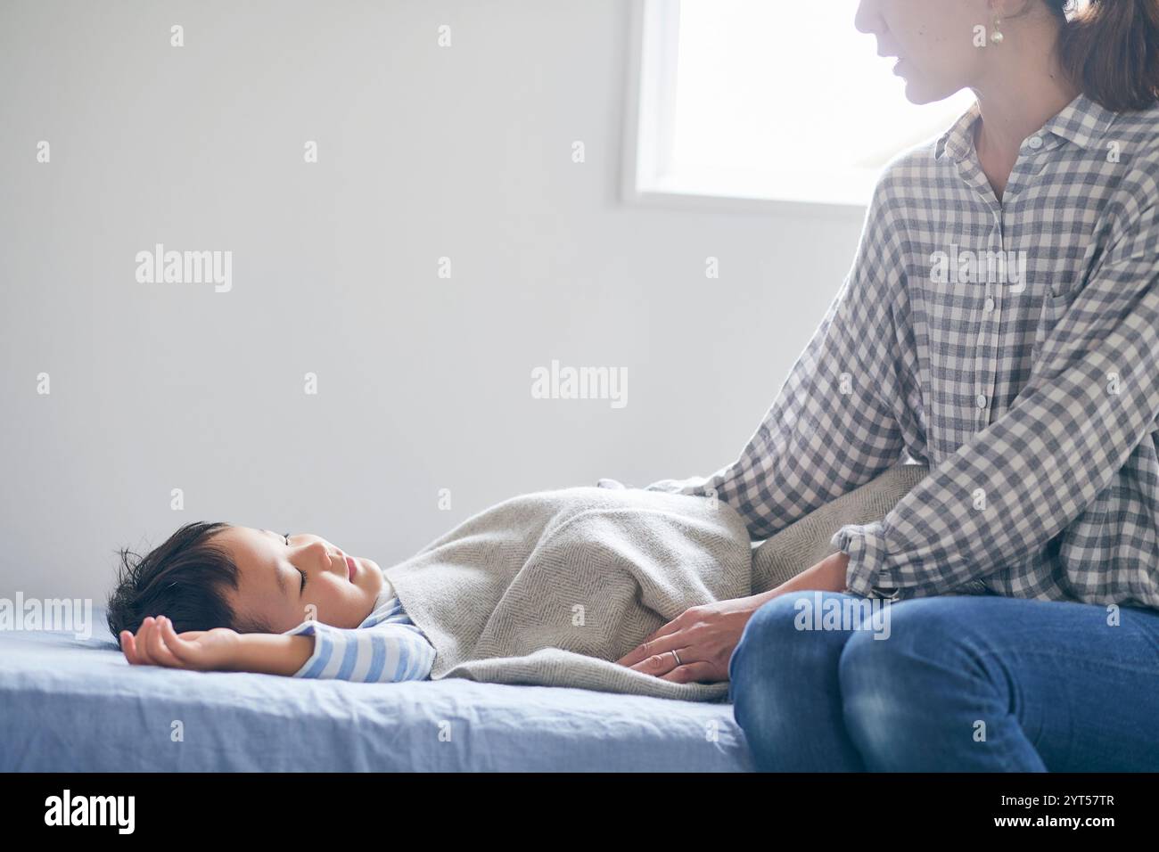 Boy and mother taking a nap Stock Photo - Alamy