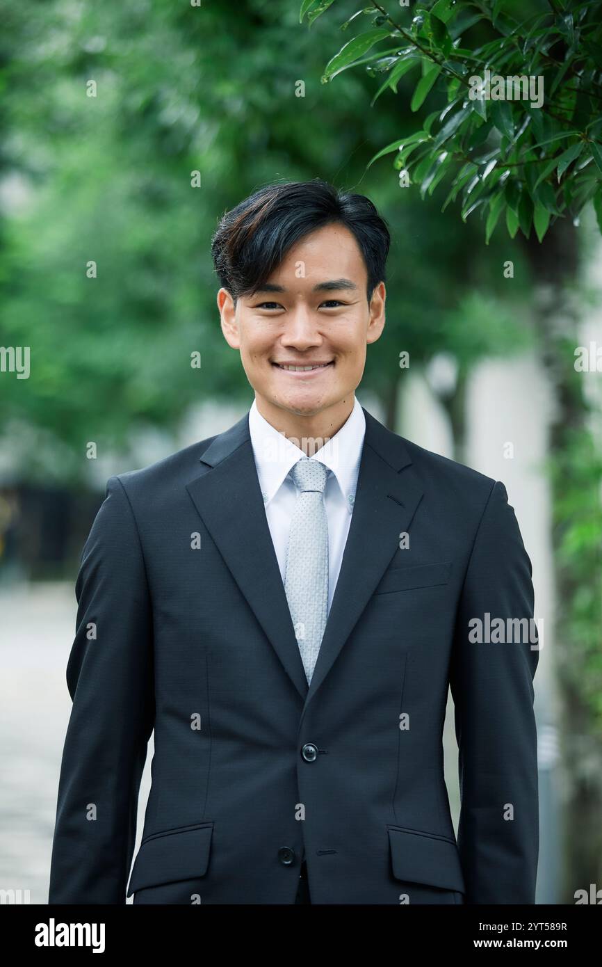 Businessman standing in front of a building hi-res stock photography ...