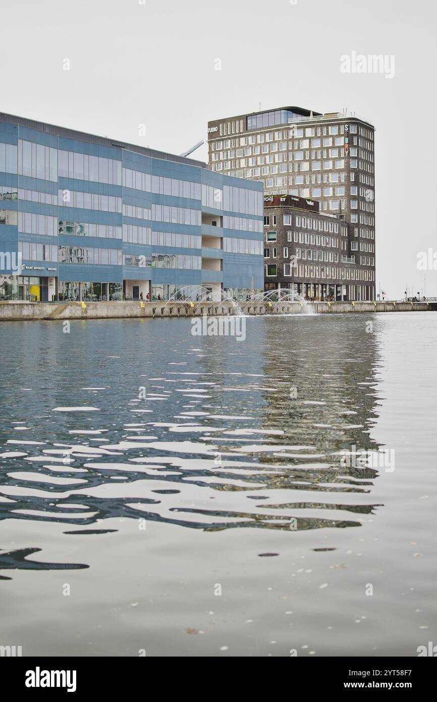 Malmo University building reflected in water Stock Photo - Alamy