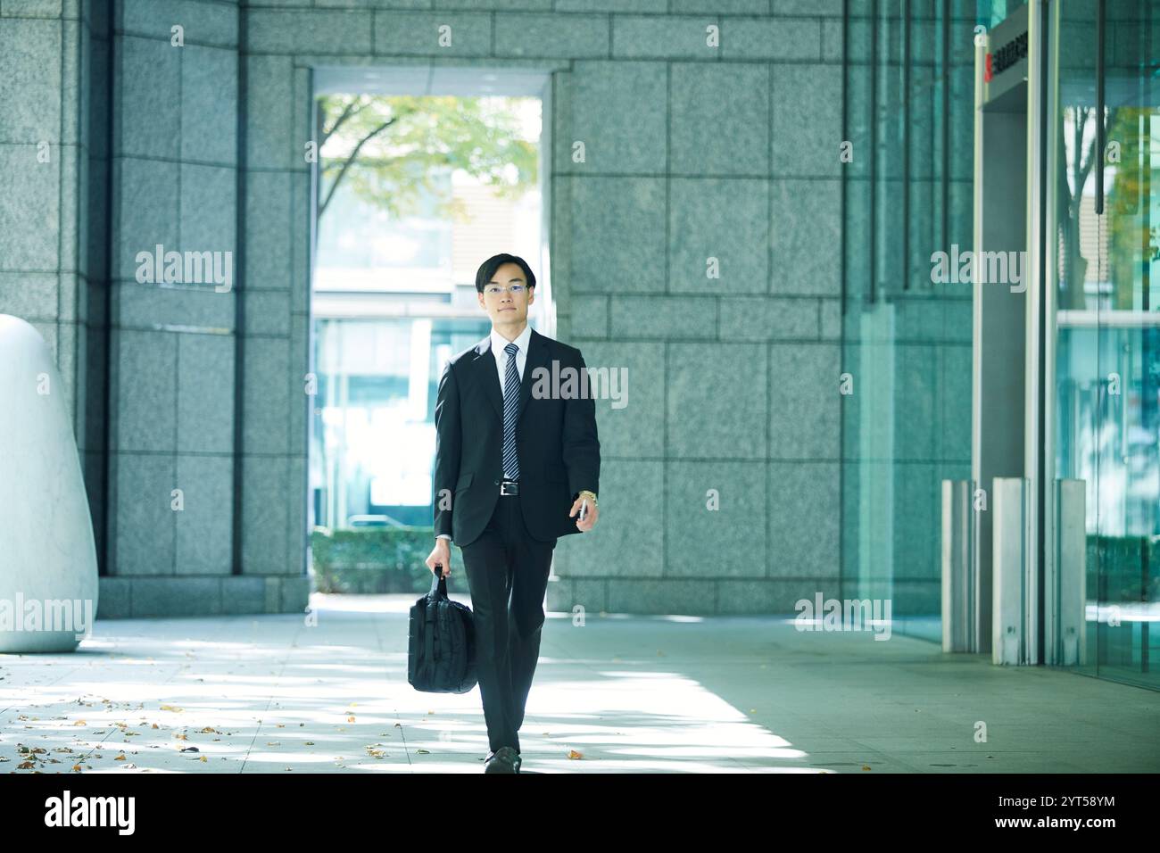 Businessmen walking in an office block Stock Photo - Alamy