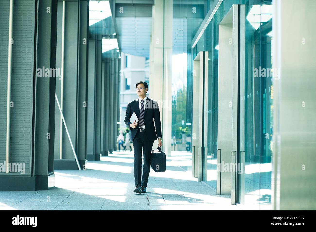 Businessmen walking in an office block Stock Photo - Alamy