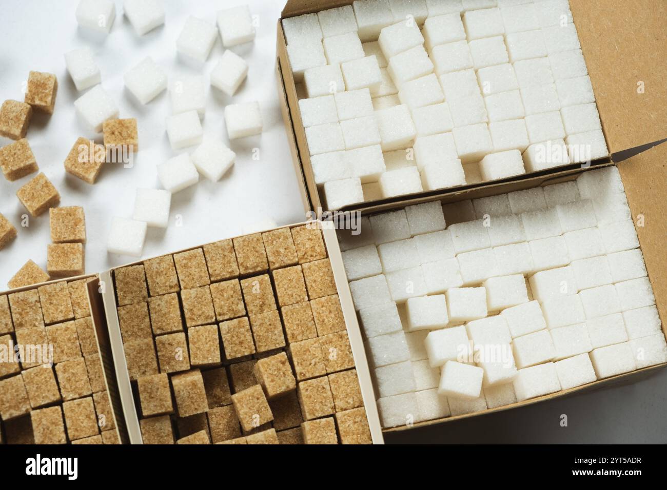 Cubes of demerara cane sugar and white beet sugar top view Stock Photo ...