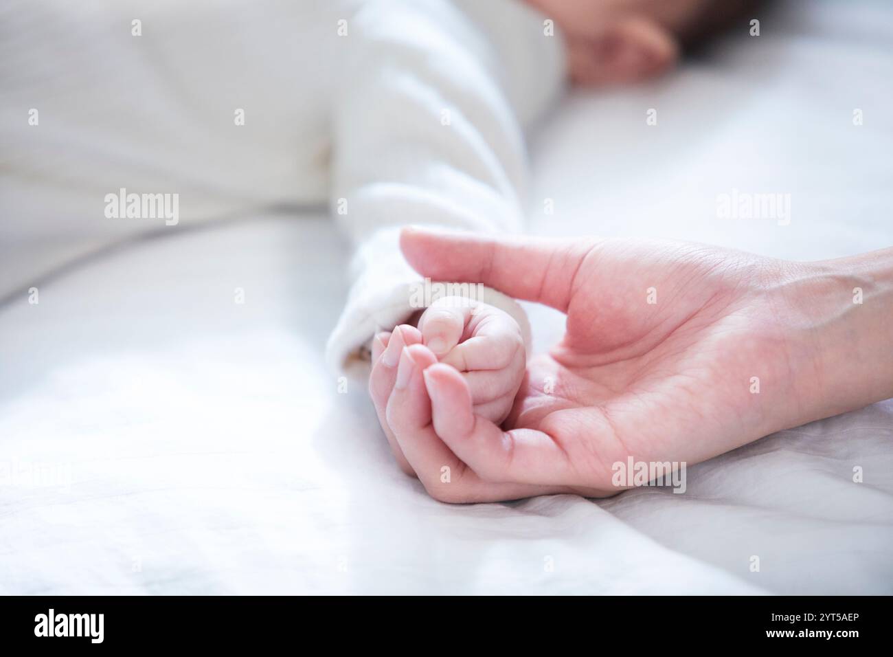Baby's hand and mother's hand Stock Photo - Alamy