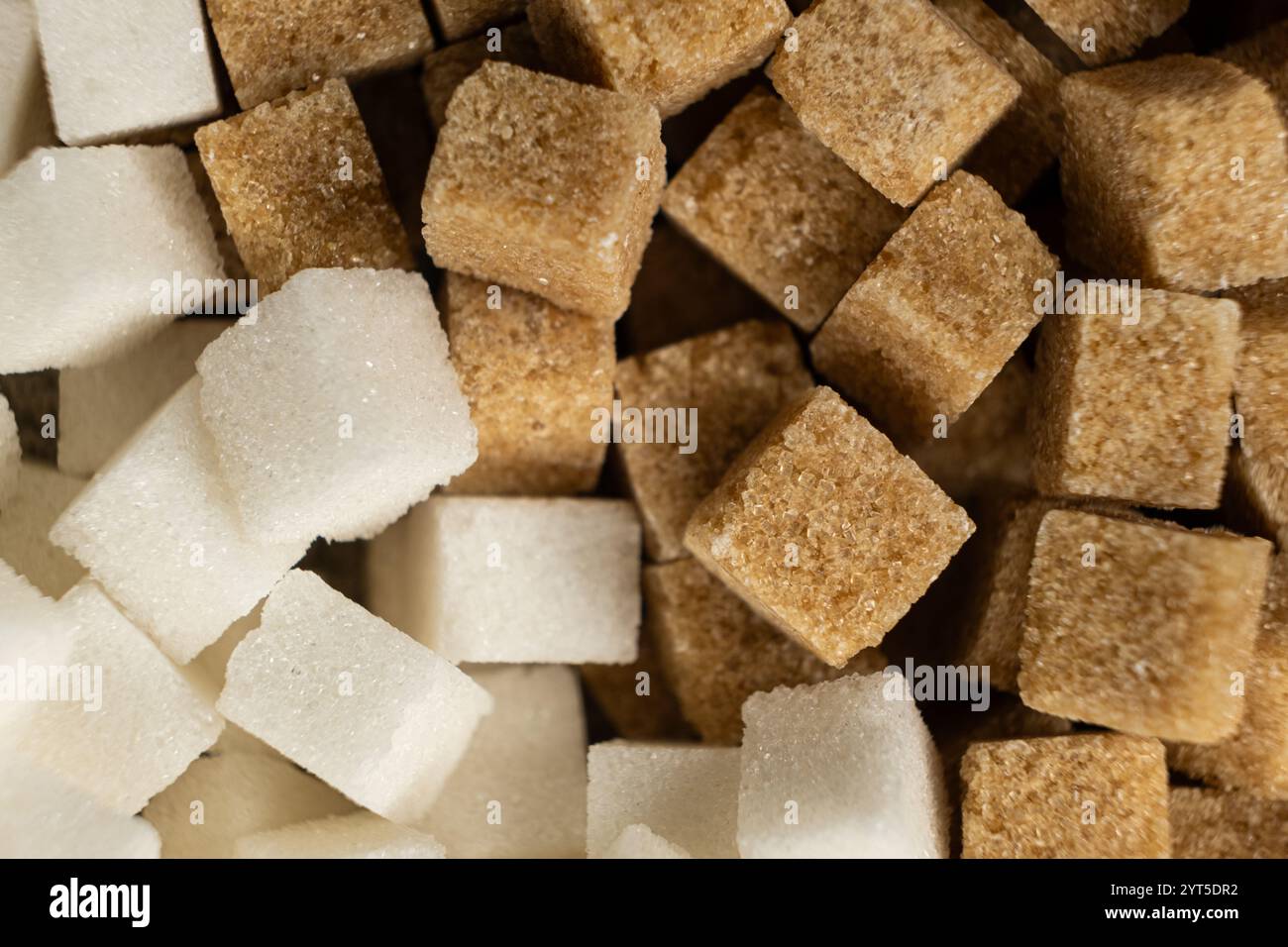 Cubes of unrefined brown demerara sugar and white refined beet sugar ...