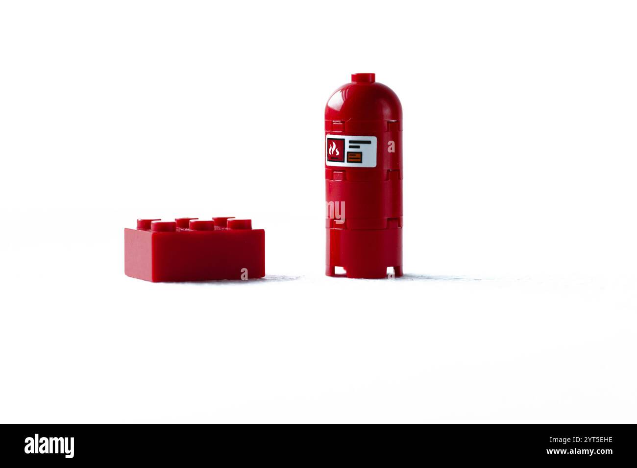 A red Lego brick is next to a red fire hydrant. The fire hydrant is red ...