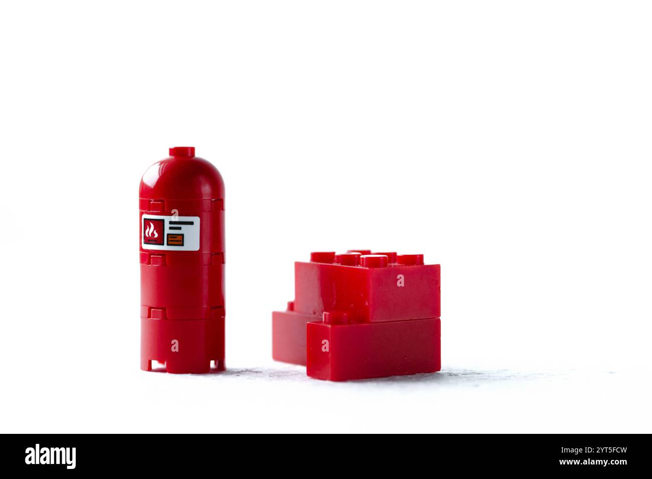 A red Lego brick is next to a red fire hydrant. The fire hydrant is red ...