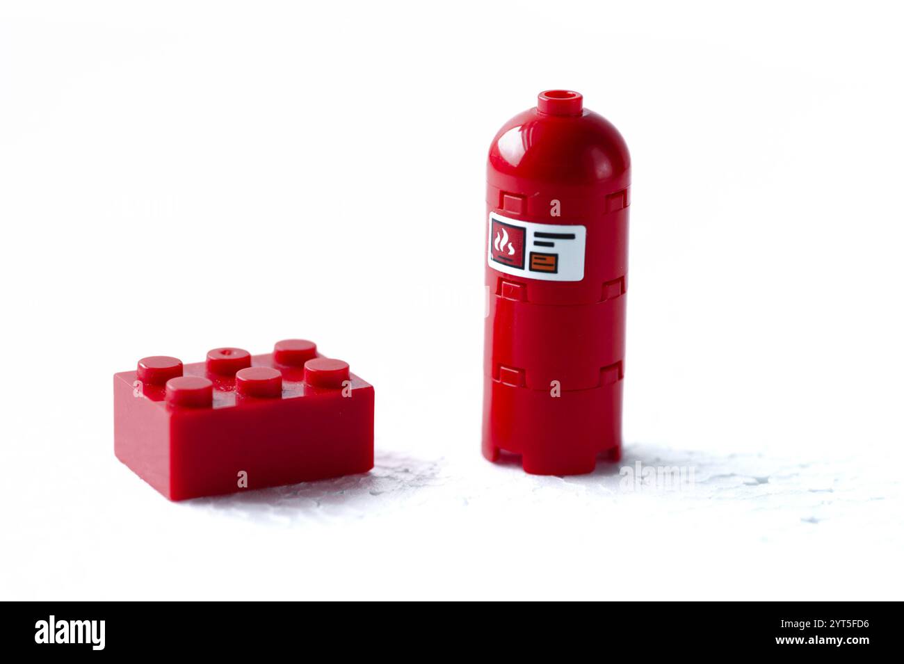 A red Lego brick is next to a red fire hydrant. The fire hydrant is red ...