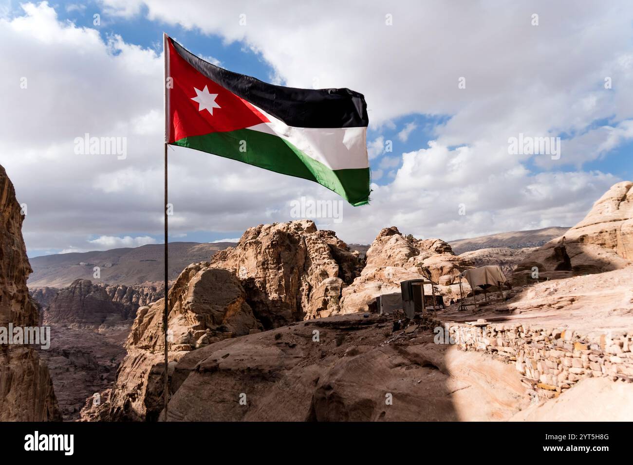 The flag of Jordan blowing in the wind in Petra, Jordan. Three-color ...