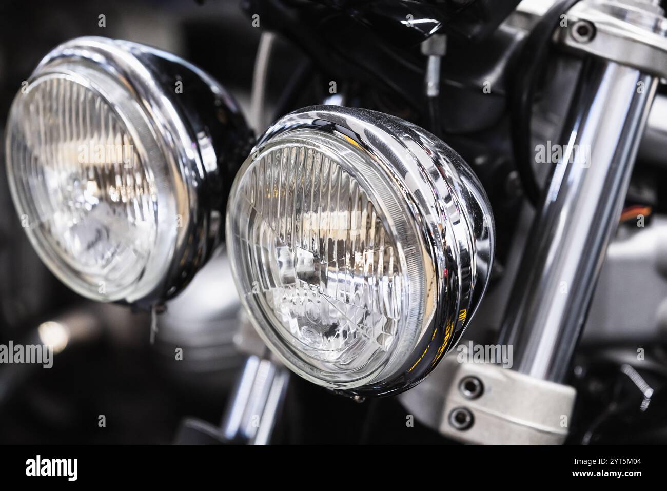 Round front headlights of a shiny black road motorcycle, close up photo ...