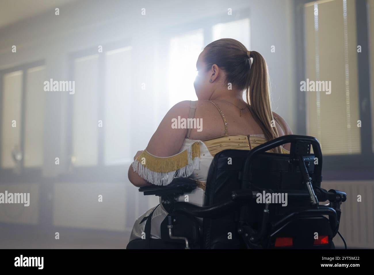 Woman on electric wheelchair performing para dance choreography. Aspiration, determination, and ...