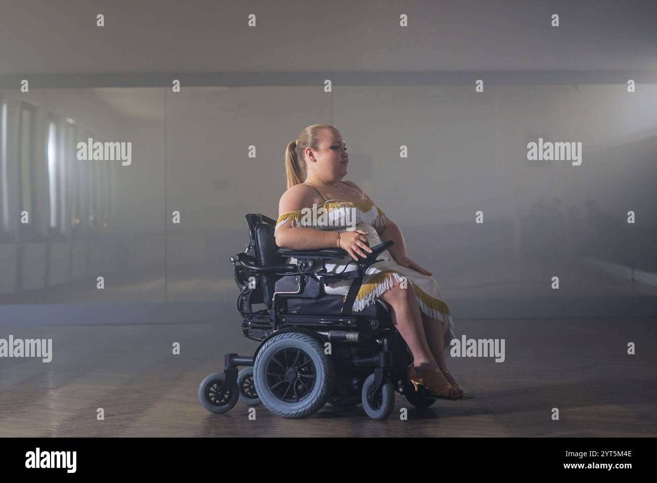 Woman on electric wheelchair performing para dance choreography. Aspiration, determination, and ...