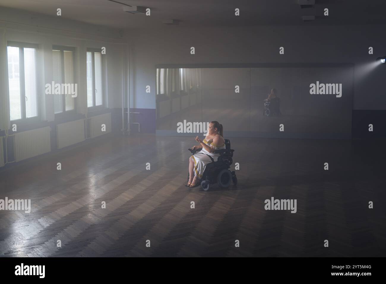 Elegant dressed-up woman with disability dancing in an electric ...