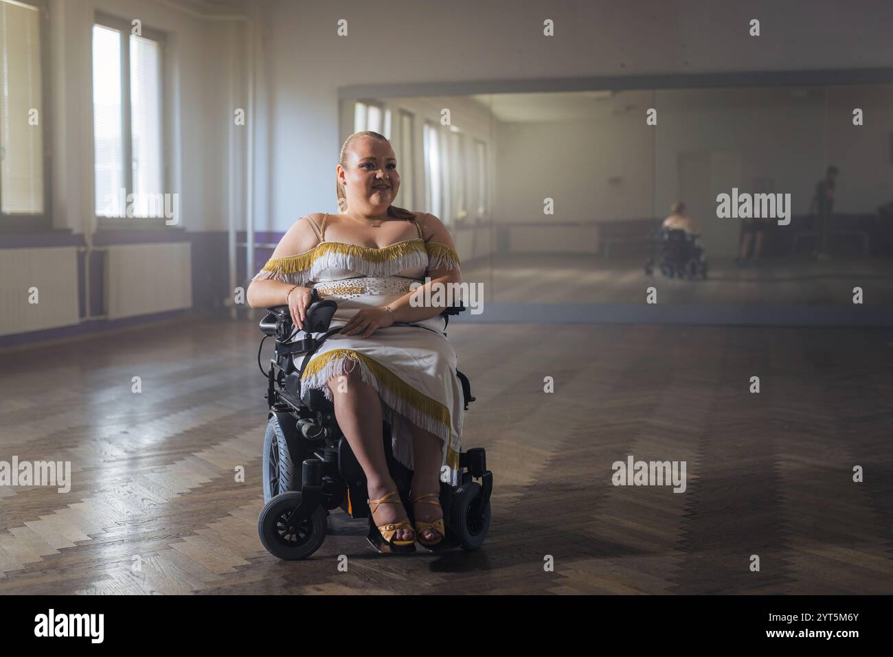 Confident pretty young woman with a disability, on her electric ...