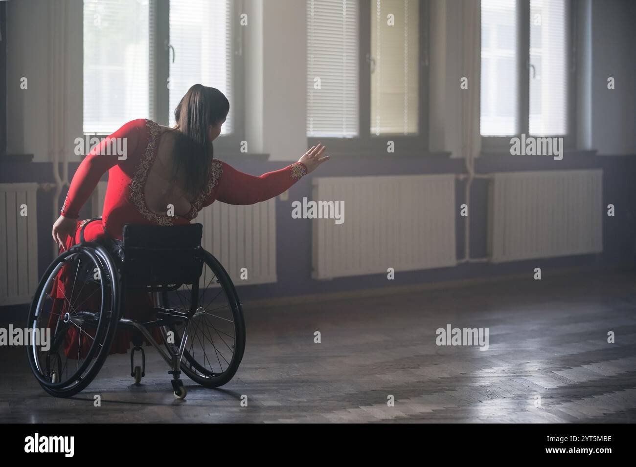 Confident young woman enjoying performing wheelchair dance in a ...