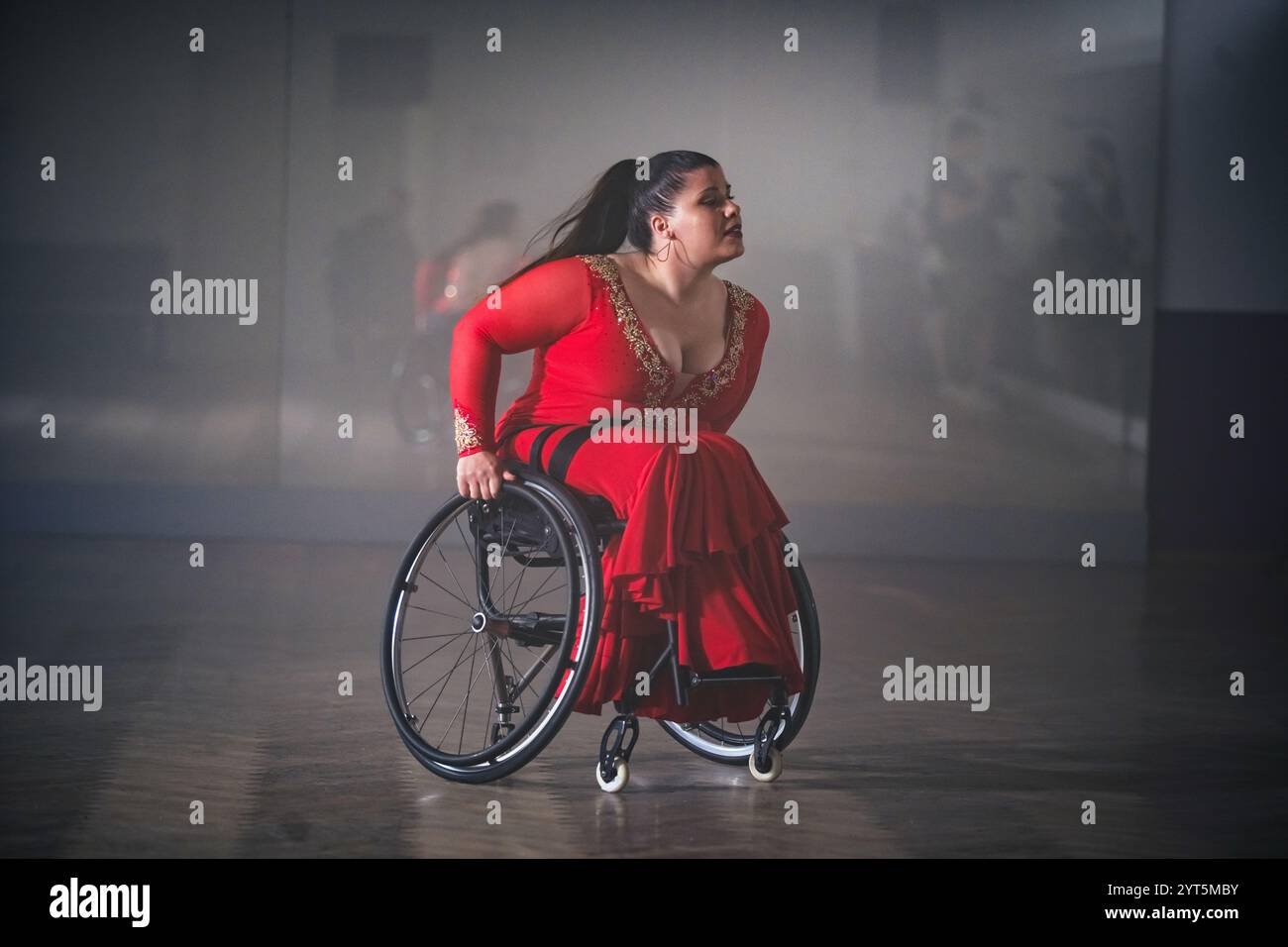 Female wheelchair dancer performing beautiful elegant choreography at a ...