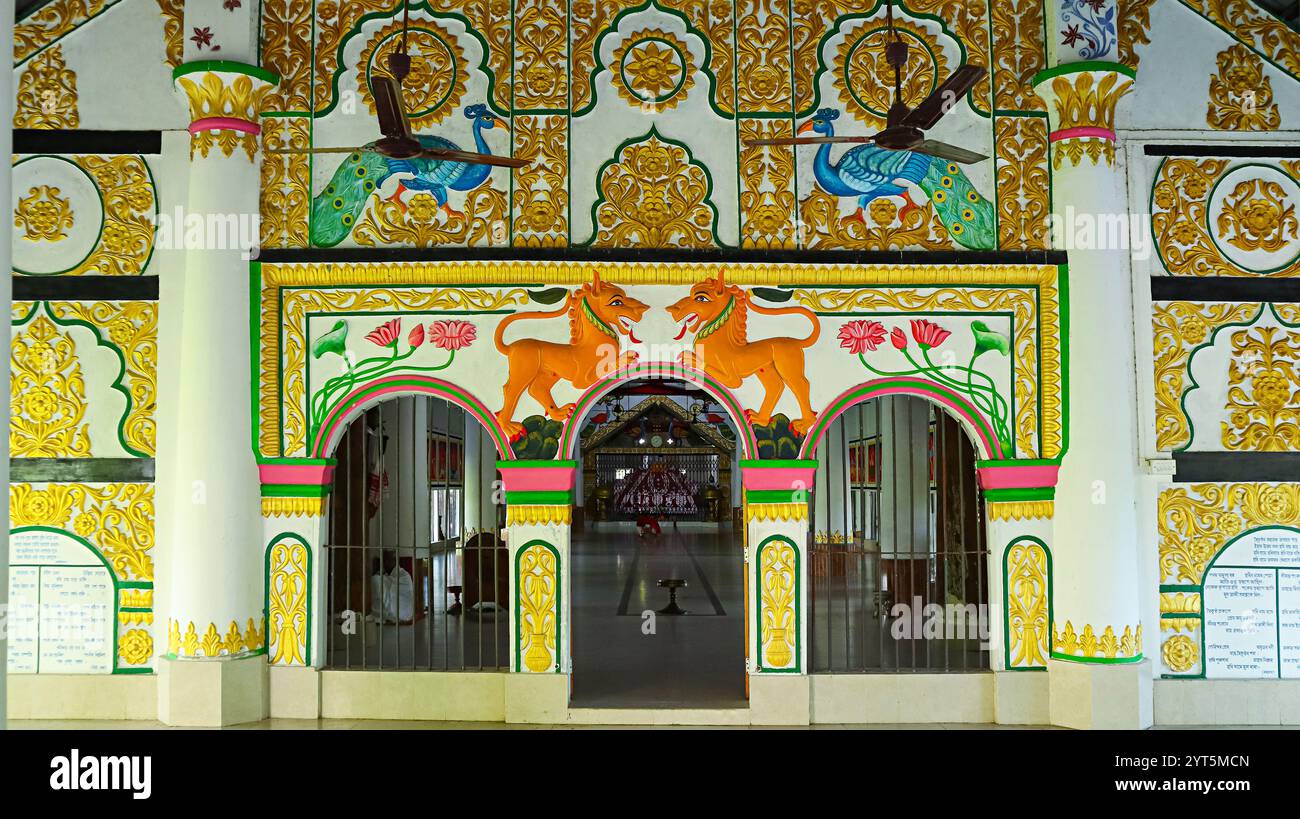 Intricate carvings adorning the entrance of the Mandapa at Uttara Kamalabari Satra, Majuli ...
