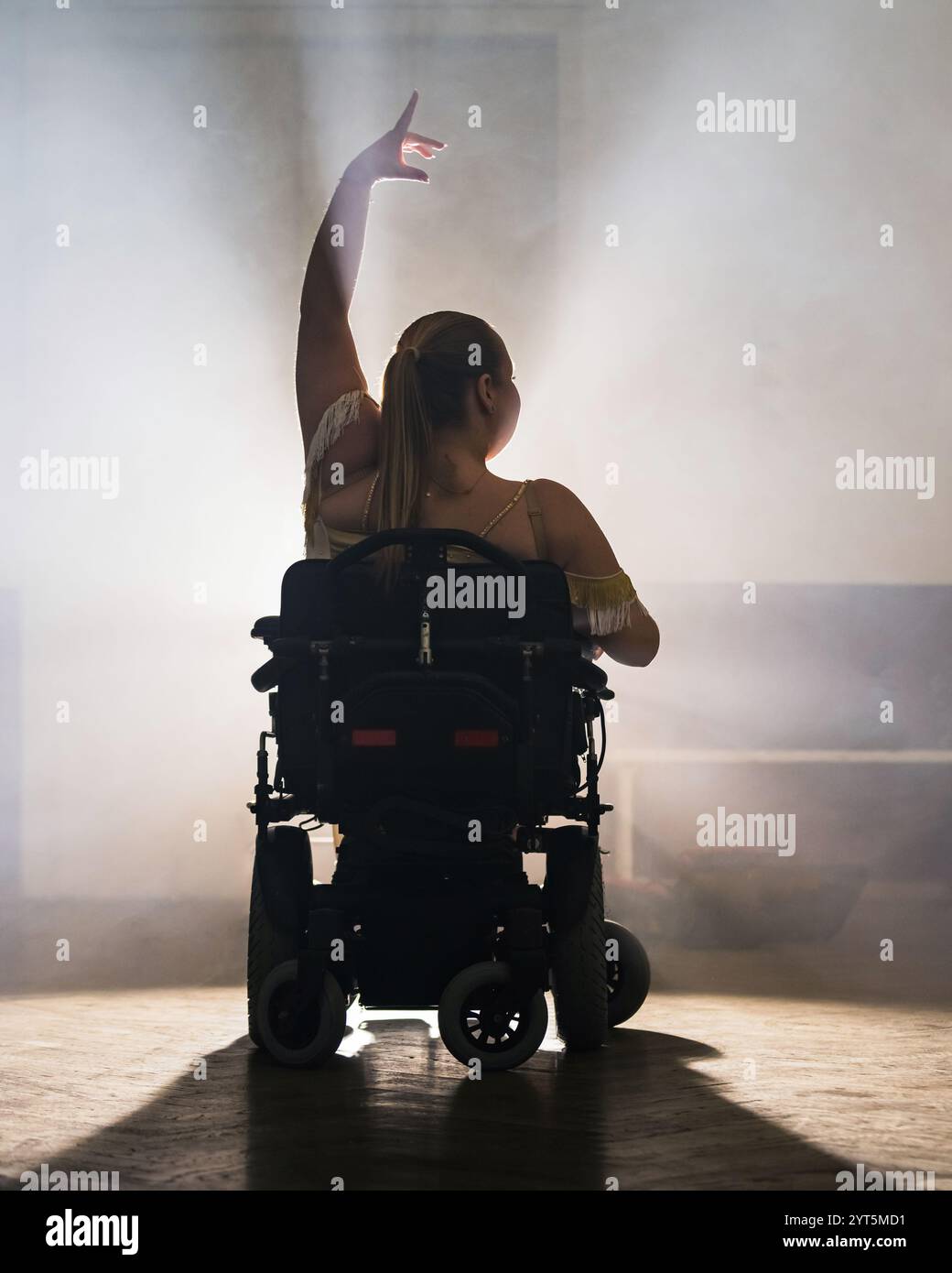 Woman practicing and performing a freestyle wheelchair dance at a ...