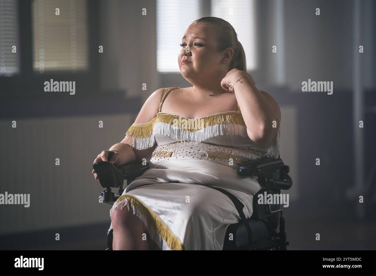 Confident pretty young woman with a disability, on her electric ...