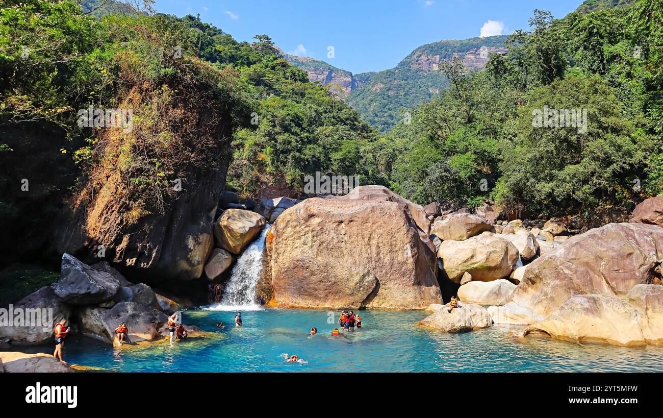 Tourists enjoying the Blue Lagoon waterfalls near the Double Decker ...