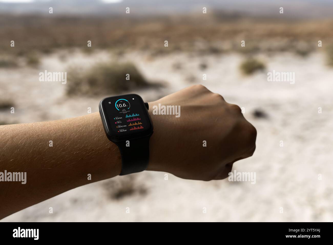 A close-up of a smartwatch displaying fitness data on a runner’s wrist ...