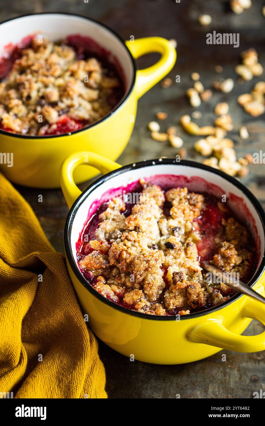 Strawberry crumble in two small yellow bowls with a yellow napkin and ...