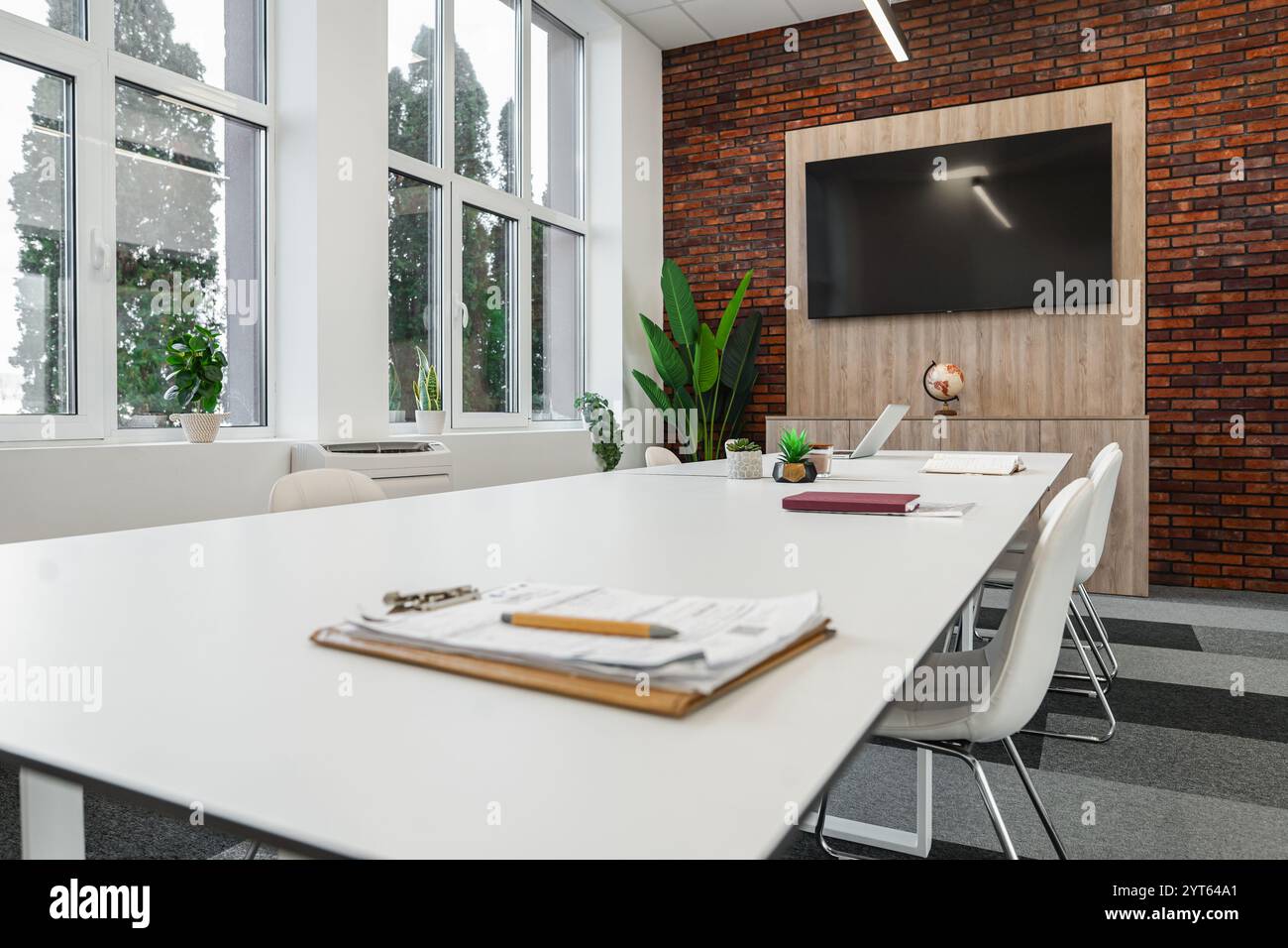A conference room featuring spacious windows allowing natural light in ...