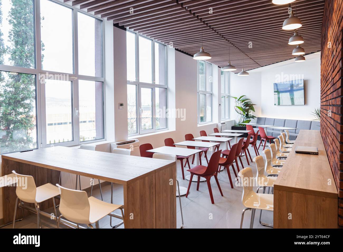 This room features a long table surrounded by numerous chairs. The ...