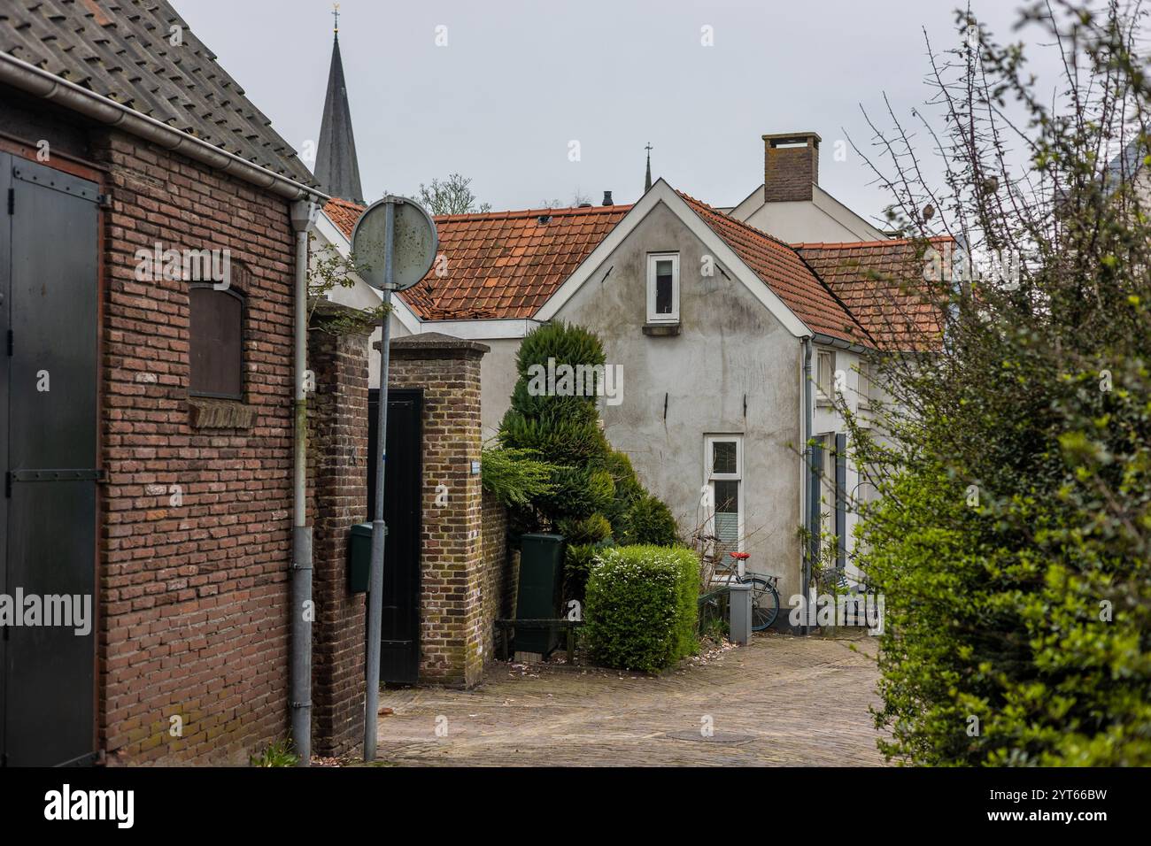 A peaceful alley with cobblestone paving, surrounded by charming houses ...