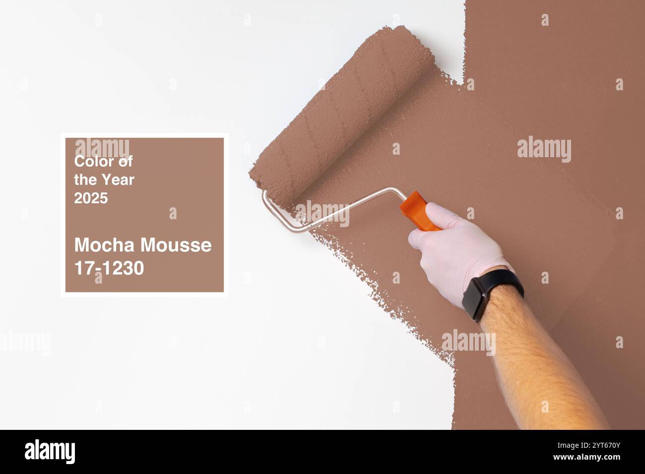 Painting a wall with mocha mousse color of the year 2025 using a roller ...