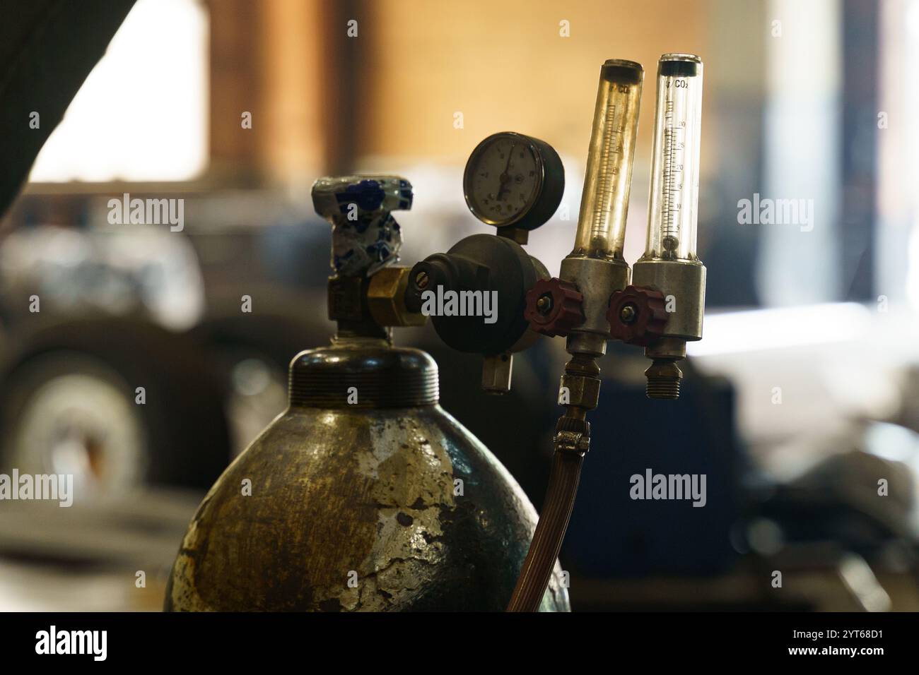 In a bustling workshop, a weathered gas cylinder stands proudly with a ...
