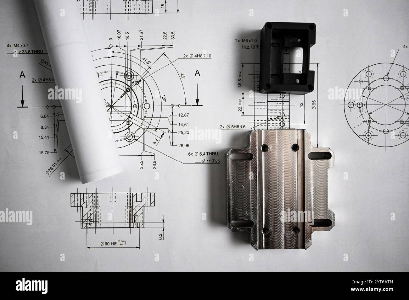 Metal components lying on mechanical engineering drawings, showcasing ... Metal components lying on mechanical engineering drawings, showcasing ...