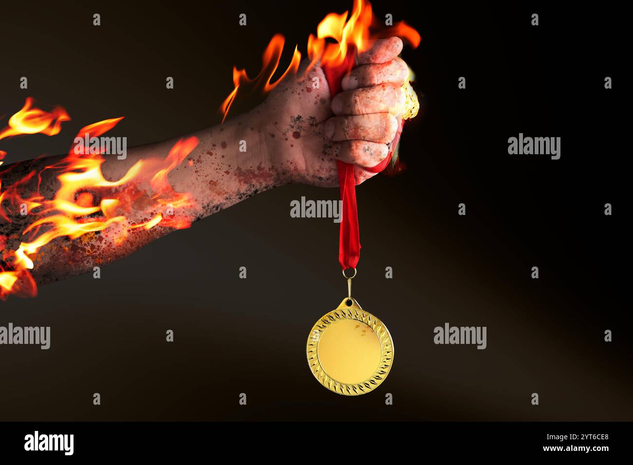 Man holding gold medal in his flaming hand on black background, closeup ...