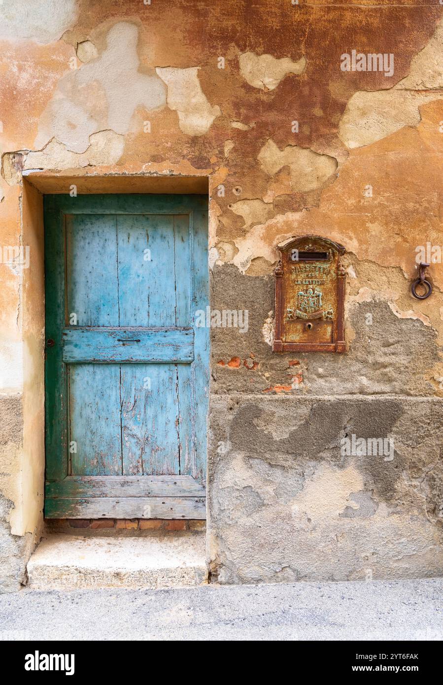Old door and mailbox in the medieval hamlet of Lucignano d'Asso, comune ...