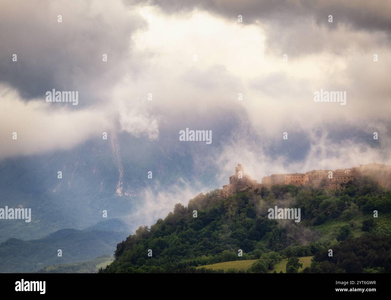 The hilltop village of Montefalcone Appennino shrouded by the lifting ...