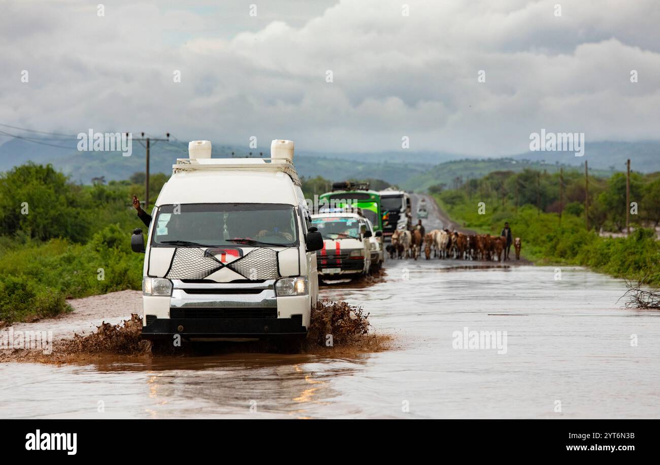 Vehicles drive through flood waters in Southern Ethiopia during flooding monsoon rains in 2024 ...