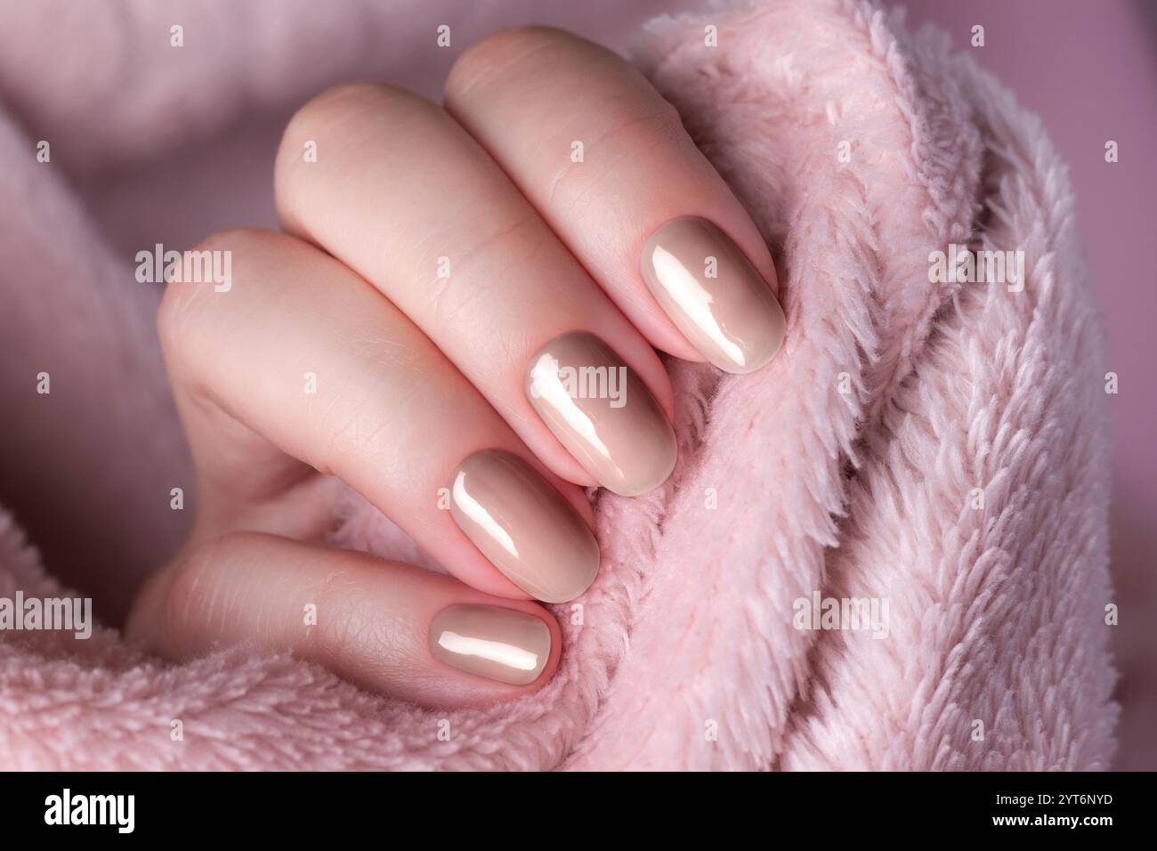 Female hand with beautiful trendy manicure - brown, mocha mousse nails ...