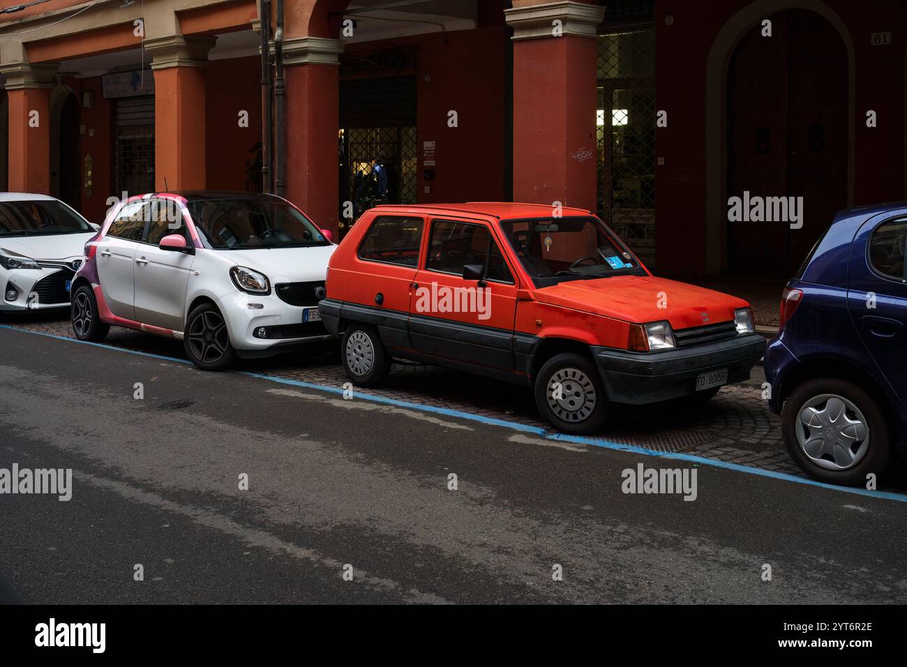 bologna, Italy. October 9, 2024 - Modern and classic cars parked in a ...