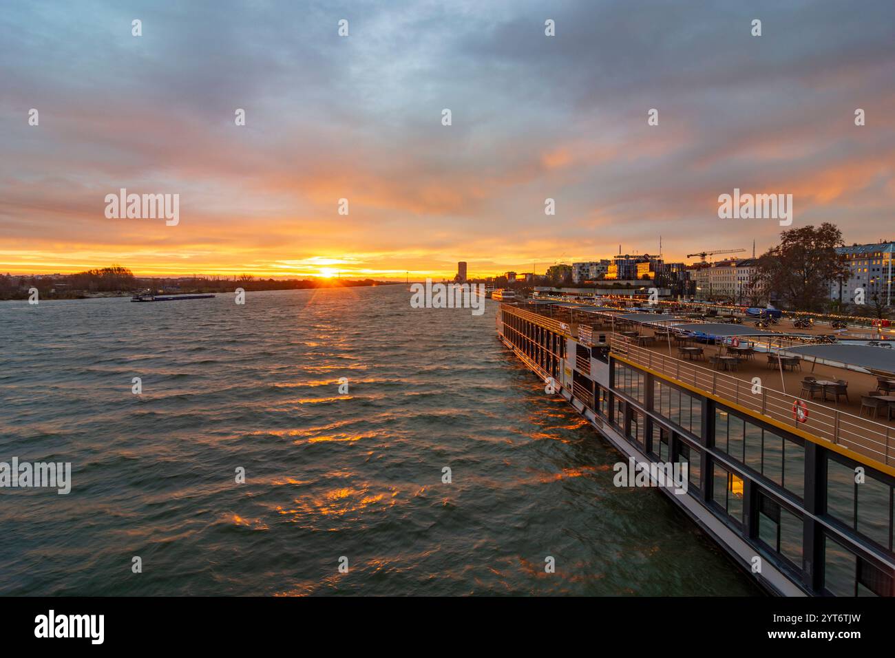 sunrise on river Donau Danube, cruise ships at terminal bridge ...