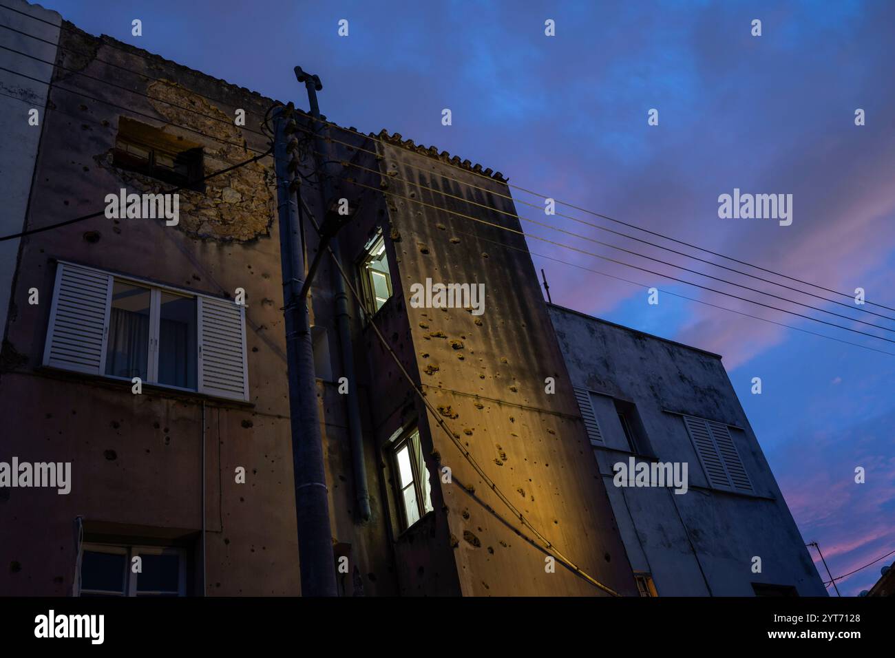 Bullet-riddled walls of a building in the Kaisariani district of the ...