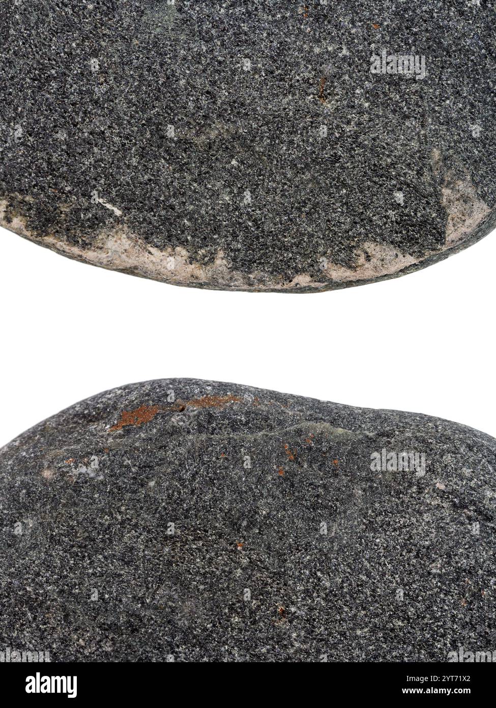 Edges of two pebbles isolated on white background with a space for text ...