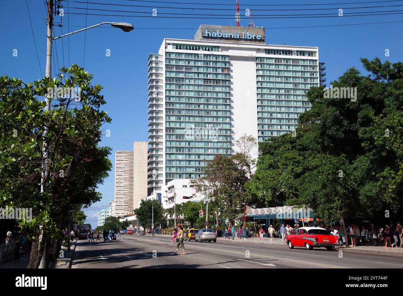 The famous Habana Libre hotel and vintage cars on the street, La Habana ...