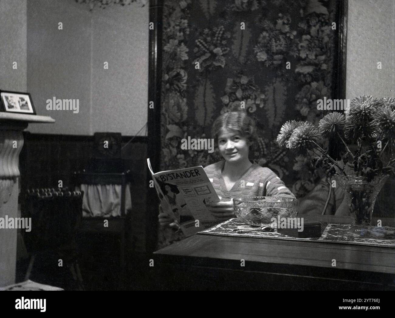 circa 1930s, historical, ayoung lady sitting in room by wooden table ...