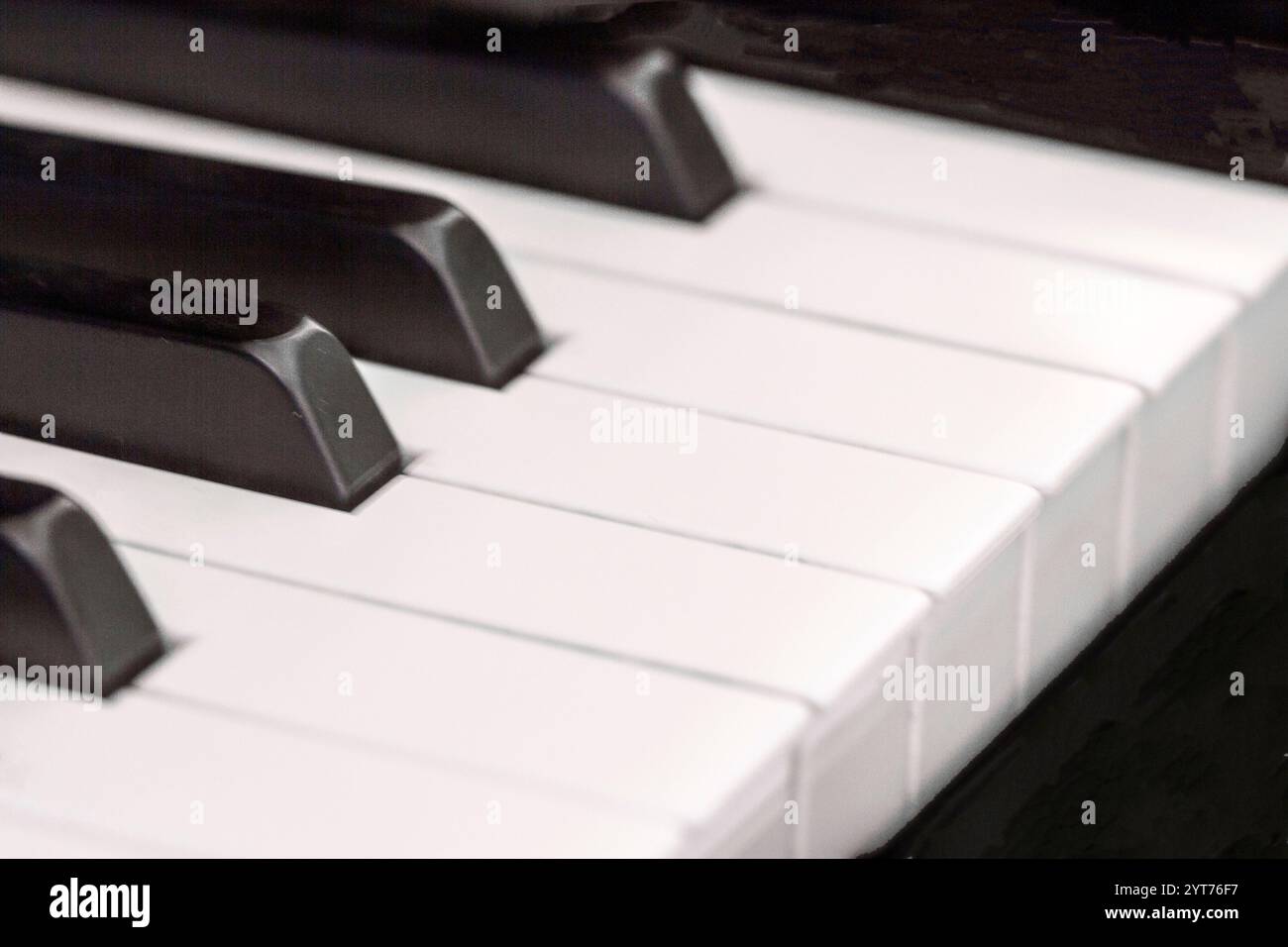 A detailed close-up photograph of piano keys highlighting the elegant ...